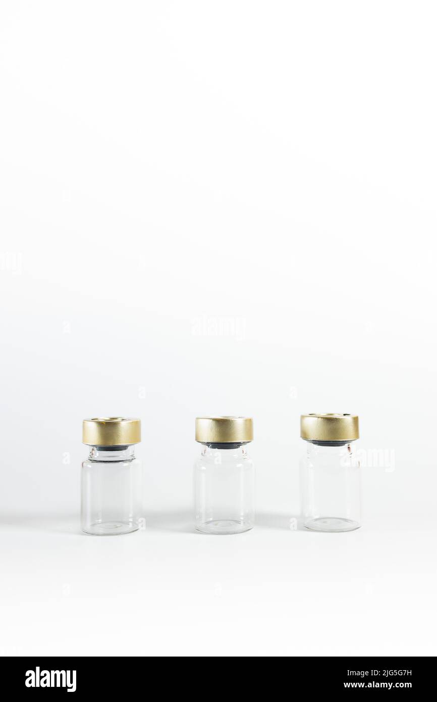 Three small empty glass vials on a white background. Medicine bottles ...