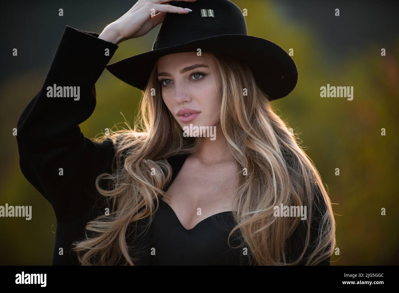 Beautiful young woman in wide broad brim hat, tender girl. Fashion and ...