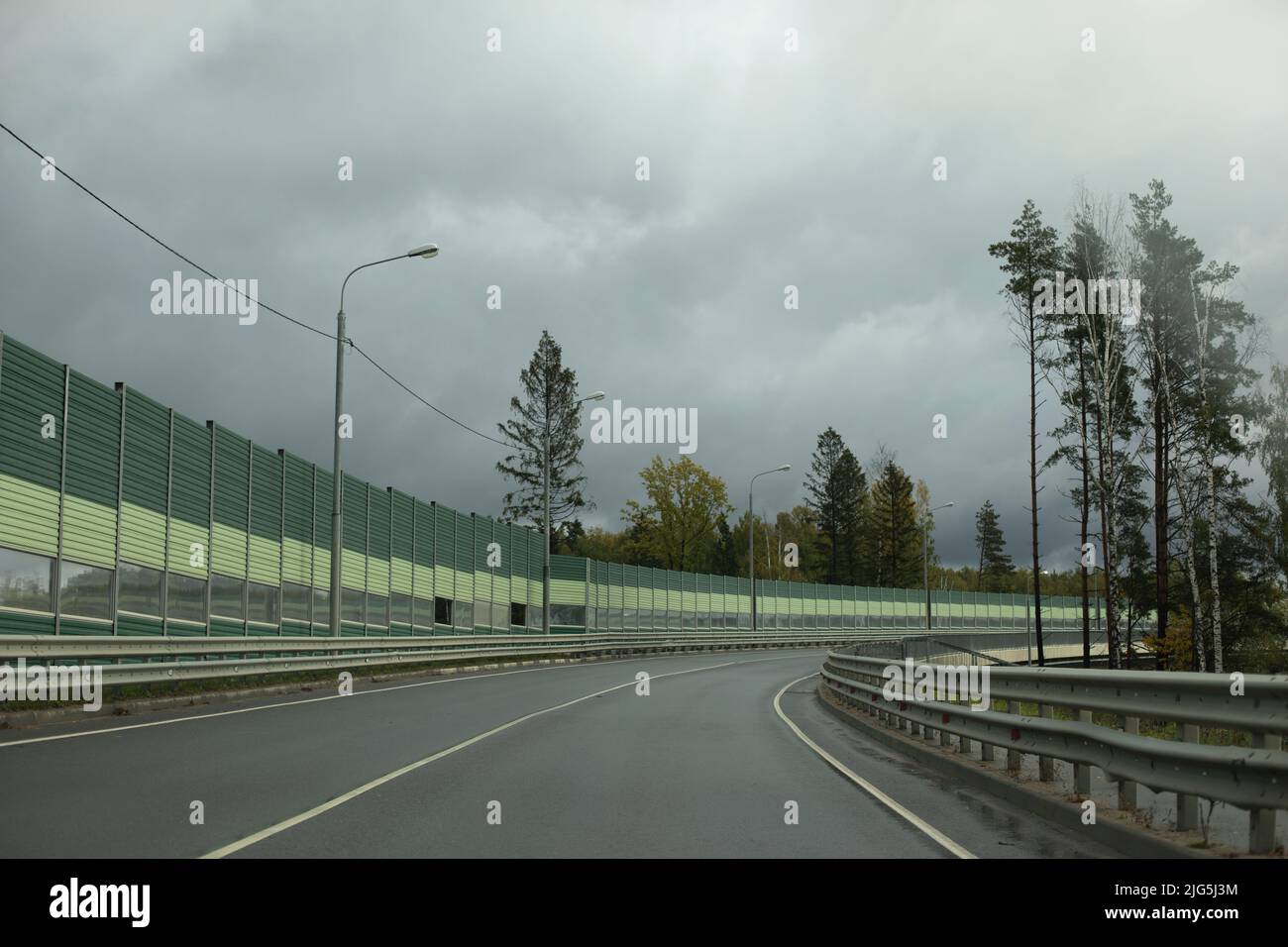 Turn on road. Fence on highway. Highway without cars. Bend of two lane ...