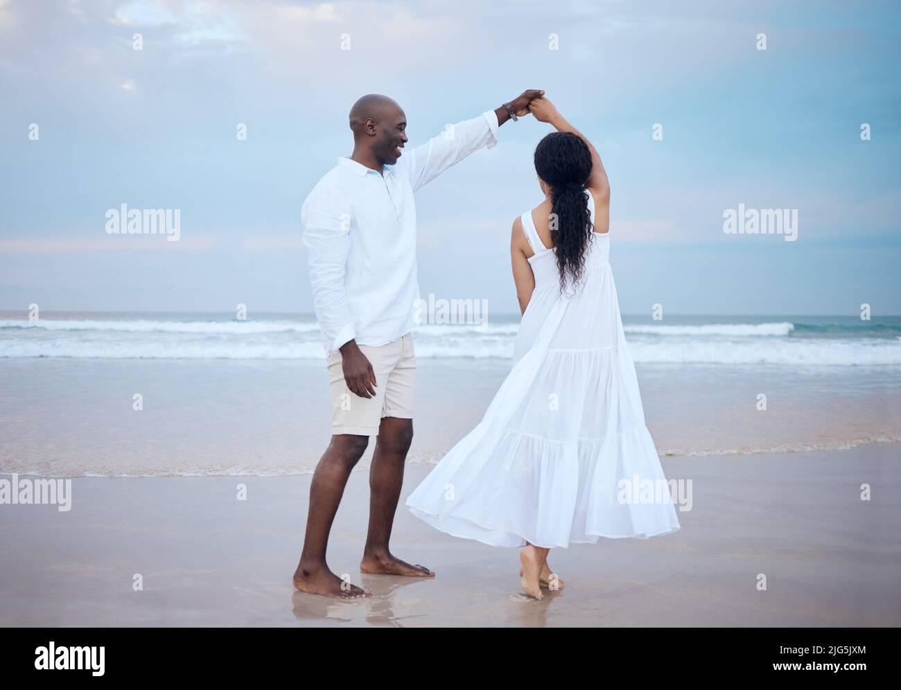 She lives for dancing in the wind. Shot of a beautiful couple spending ...