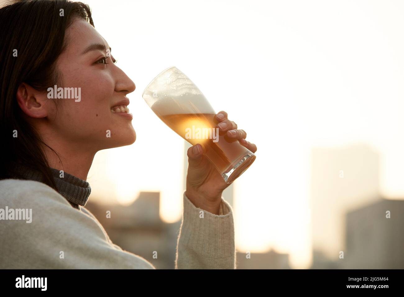 Japanese woman having a drink outside Stock Photo - Alamy