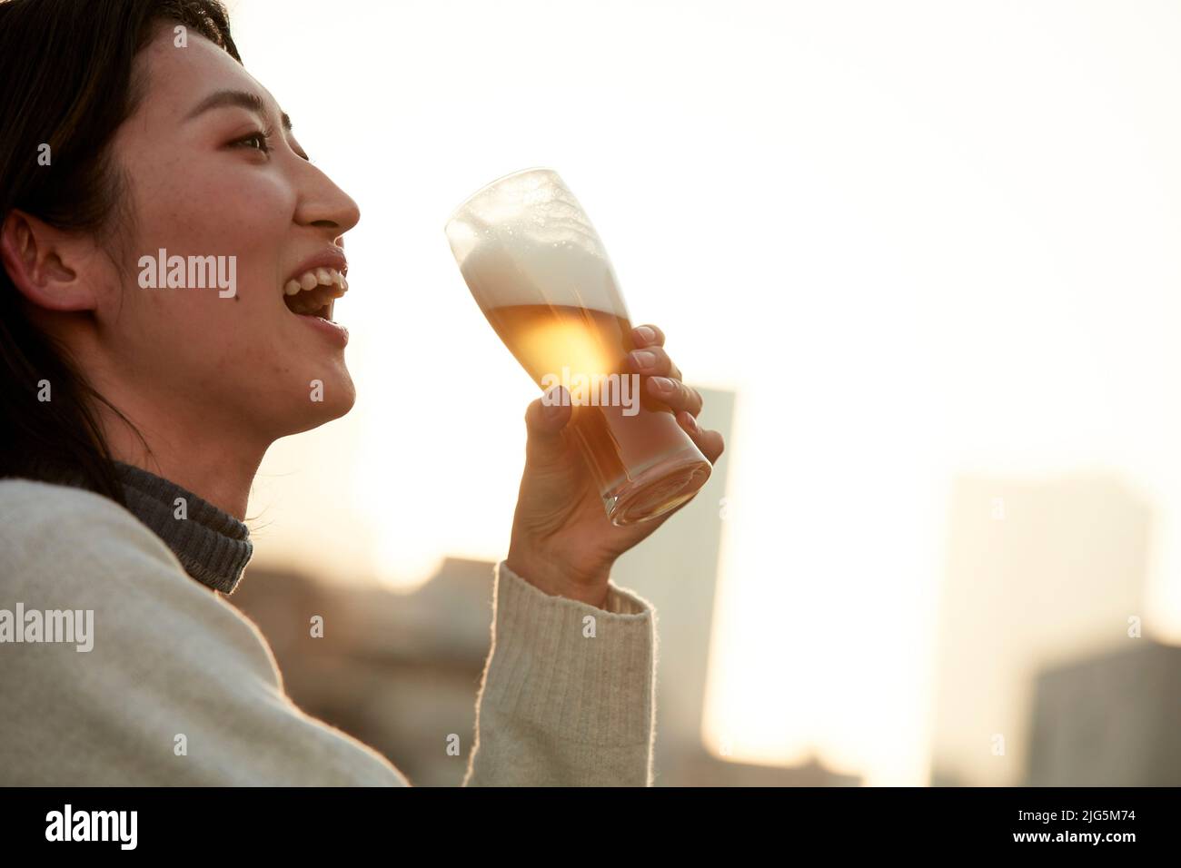 Japanese woman having a drink outside Stock Photo - Alamy
