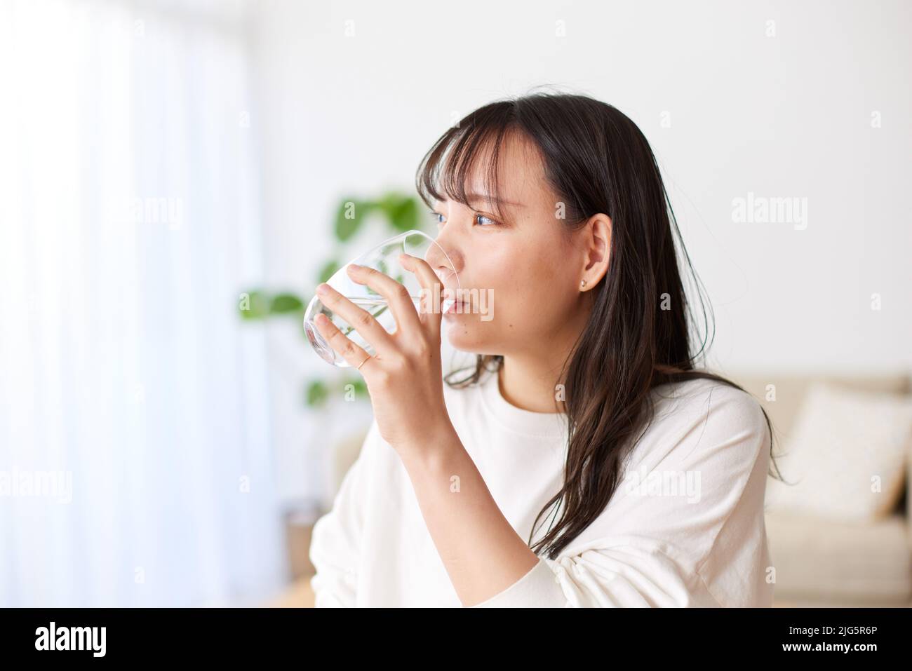 Japanese woman drinking water Stock Photo - Alamy