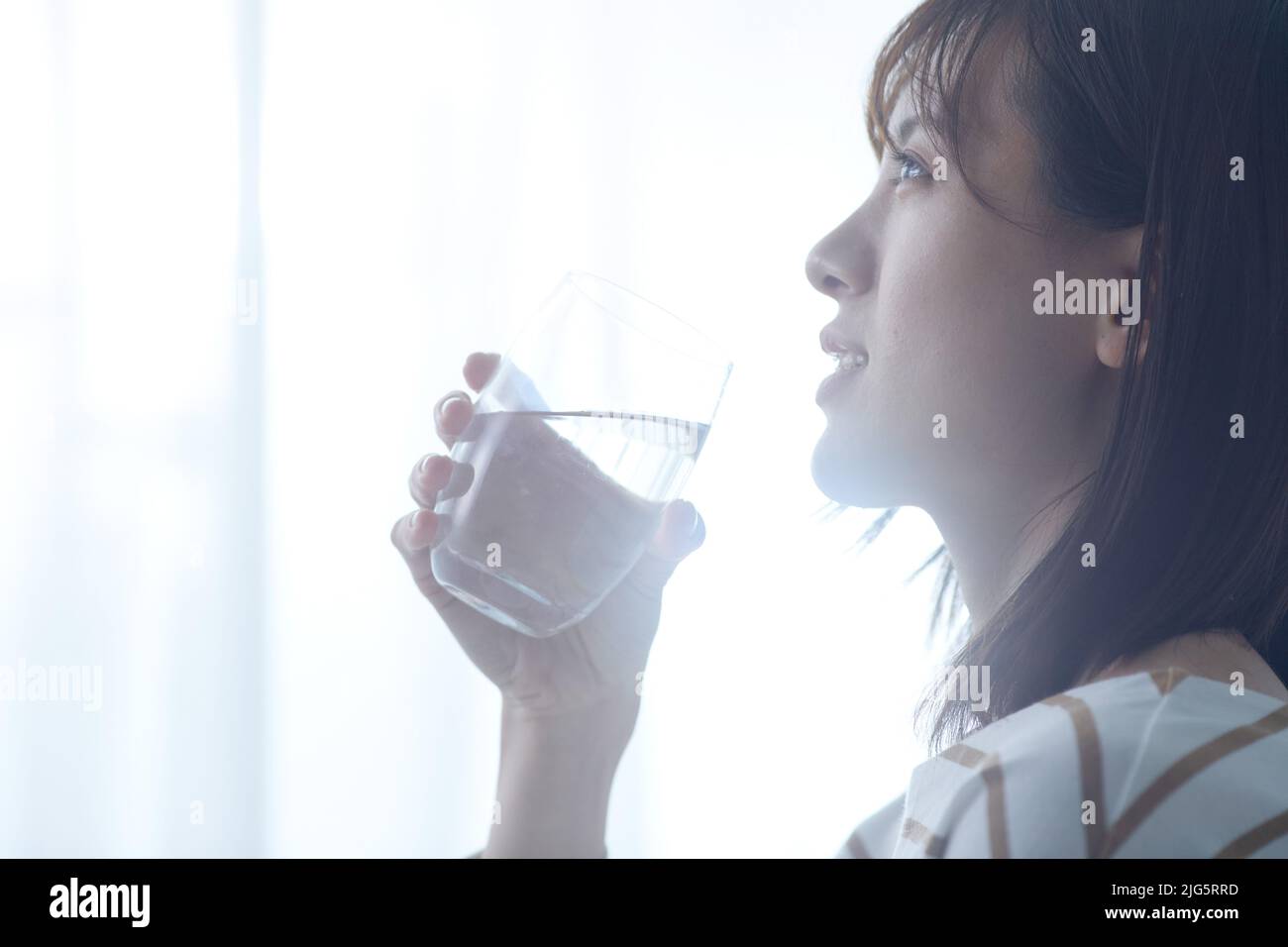 Japanese woman drinking water Stock Photo - Alamy