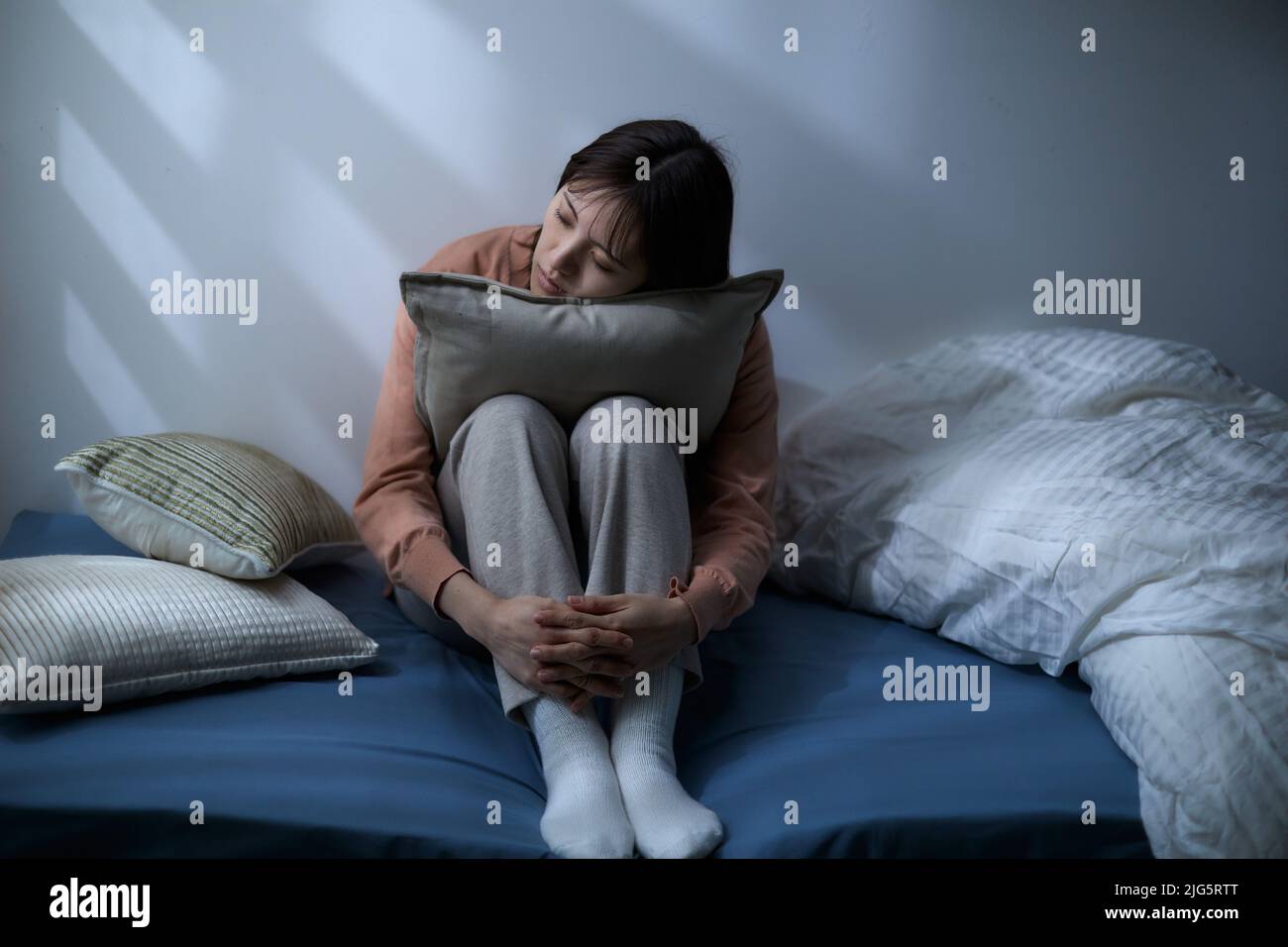 Japanese woman depressed in bed Stock Photo - Alamy