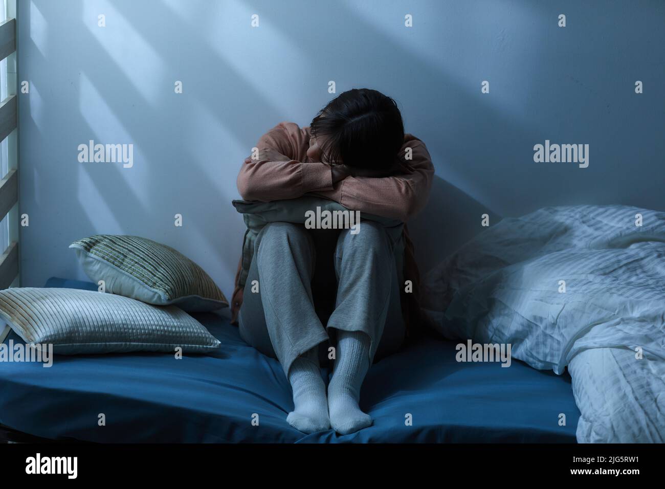 Japanese woman depressed in bed Stock Photo - Alamy