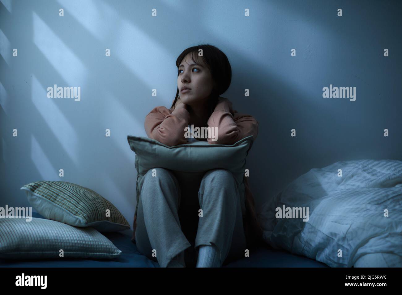 Woman crouching in pain hi-res stock photography and images - Alamy