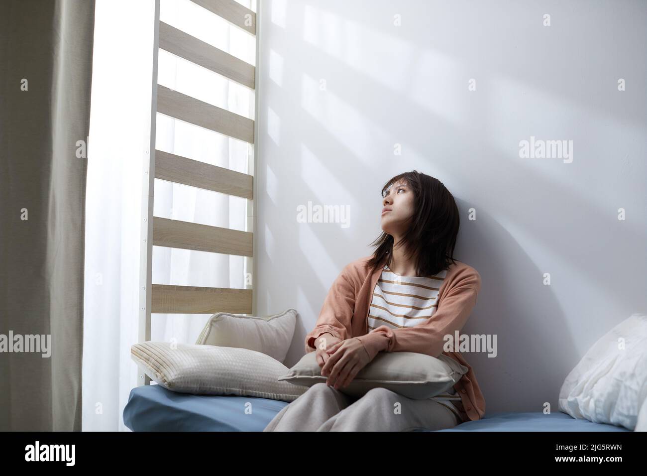 Japanese woman depressed in bed Stock Photo - Alamy
