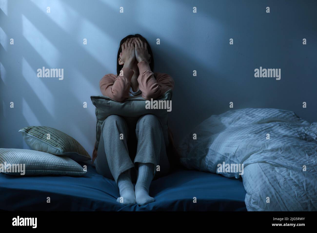 Japanese woman depressed in bed Stock Photo - Alamy