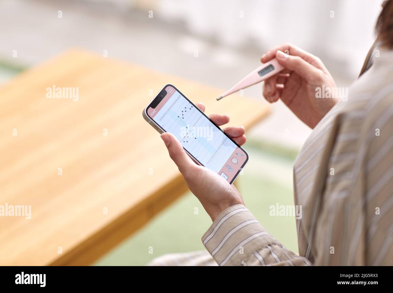 Woman checking temperature Stock Photo - Alamy