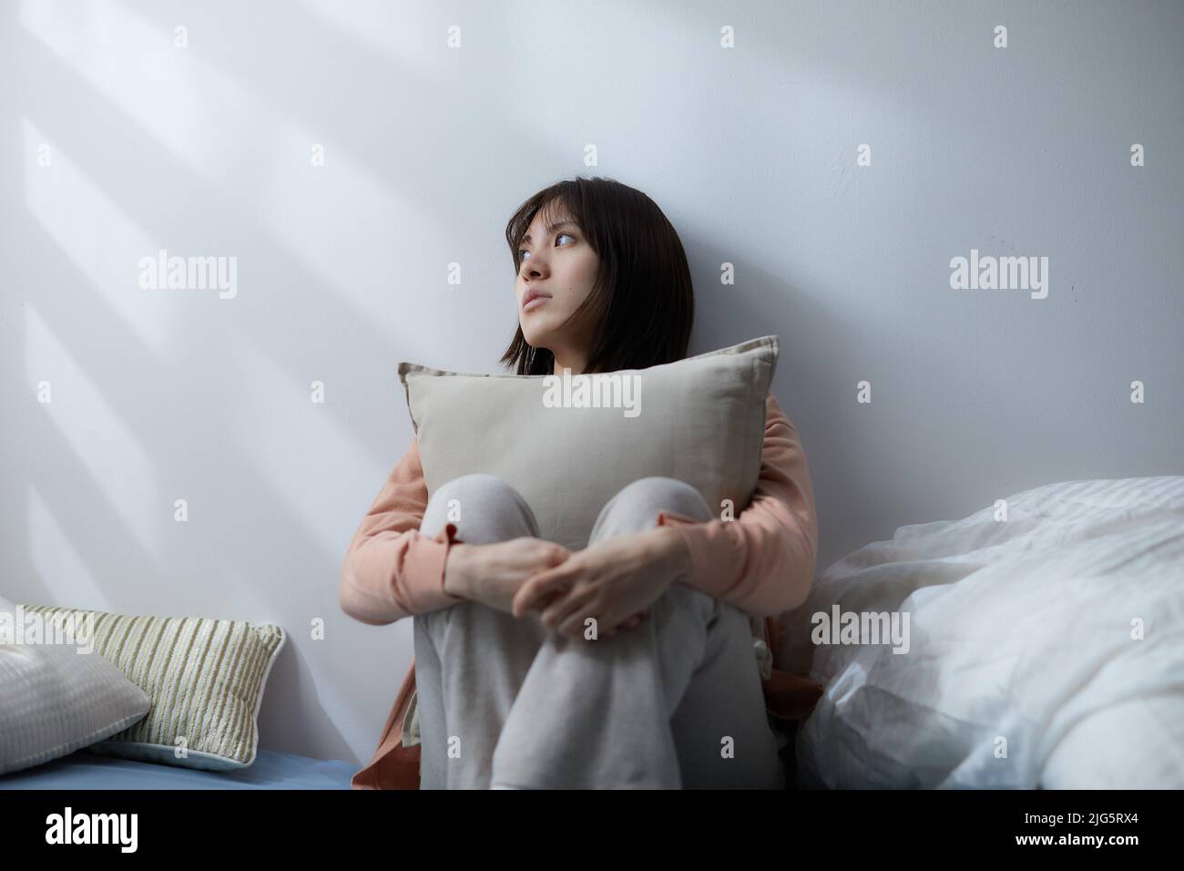 Woman crouching in pain hi-res stock photography and images - Alamy