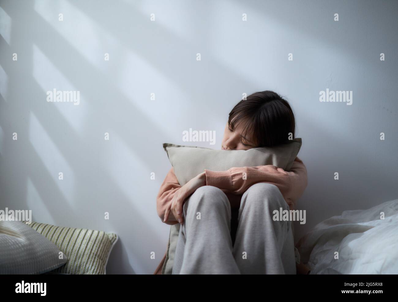 Japanese woman depressed in bed Stock Photo - Alamy