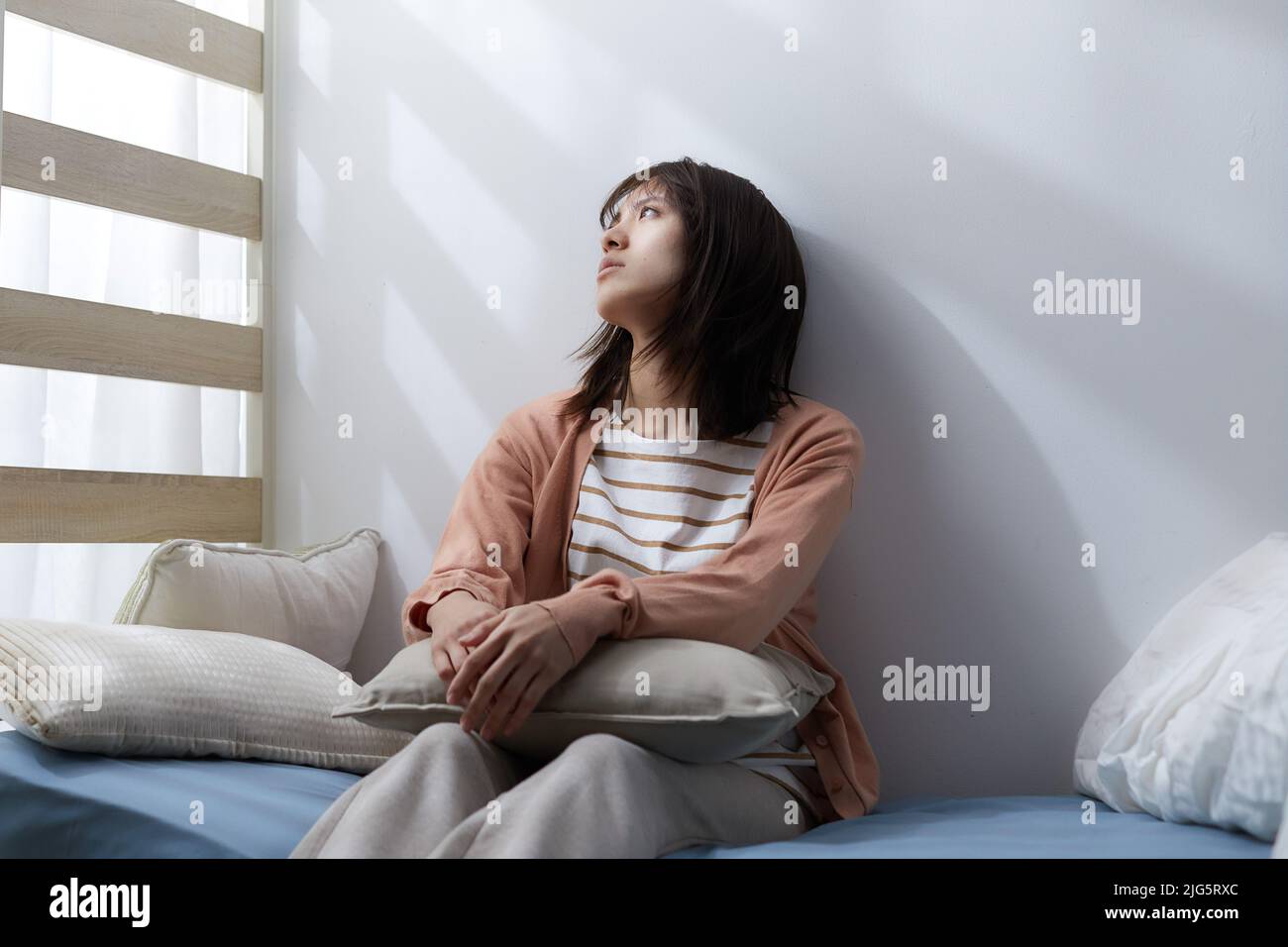 Japanese woman depressed in bed Stock Photo - Alamy