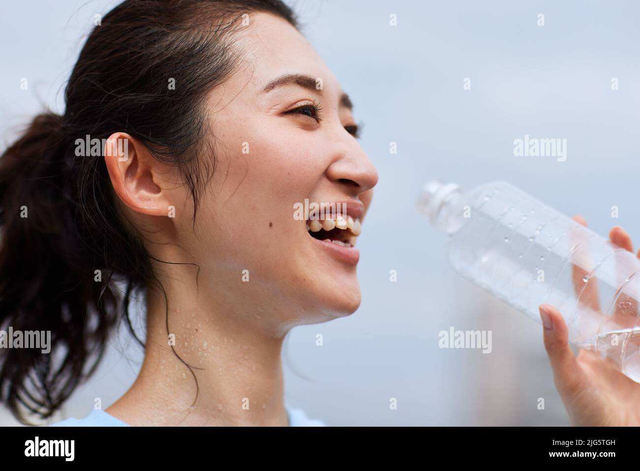 Japanese woman drinking water Stock Photo - Alamy