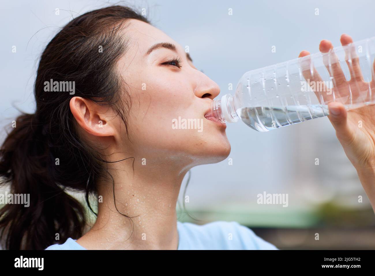 Japanese woman drinking water Stock Photo - Alamy