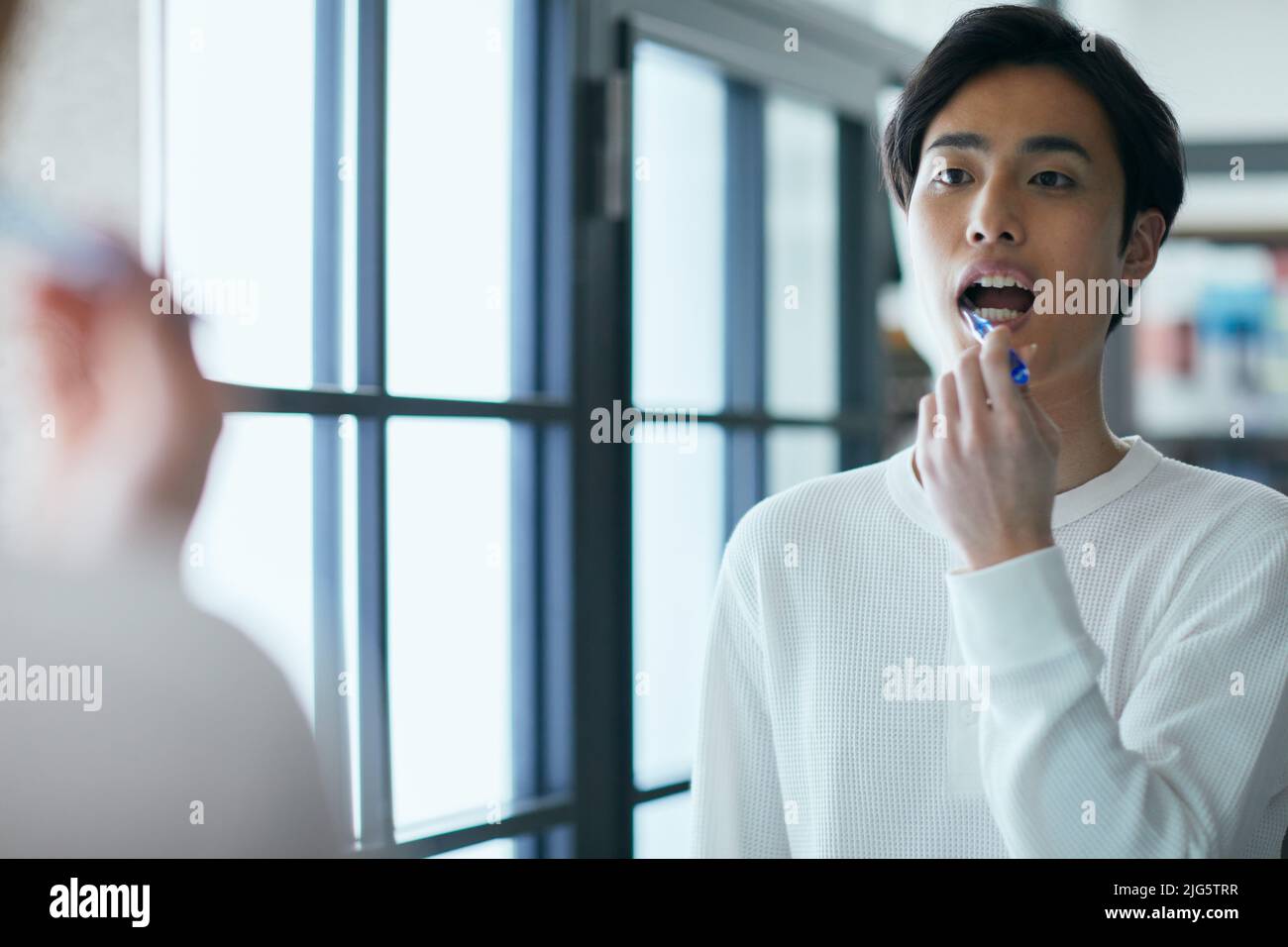 Japanese man brushing teeth Stock Photo - Alamy