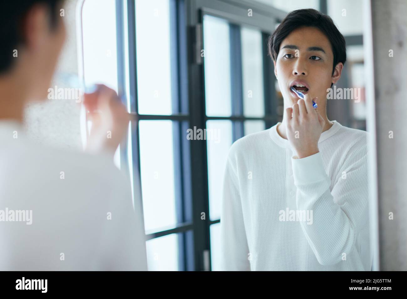 Japanese man brushing teeth Stock Photo - Alamy