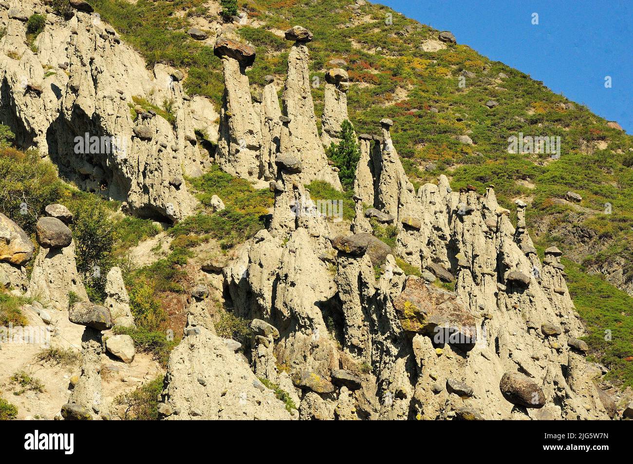 Unusual high stone formations on the slope of a high mountain. Stone ...