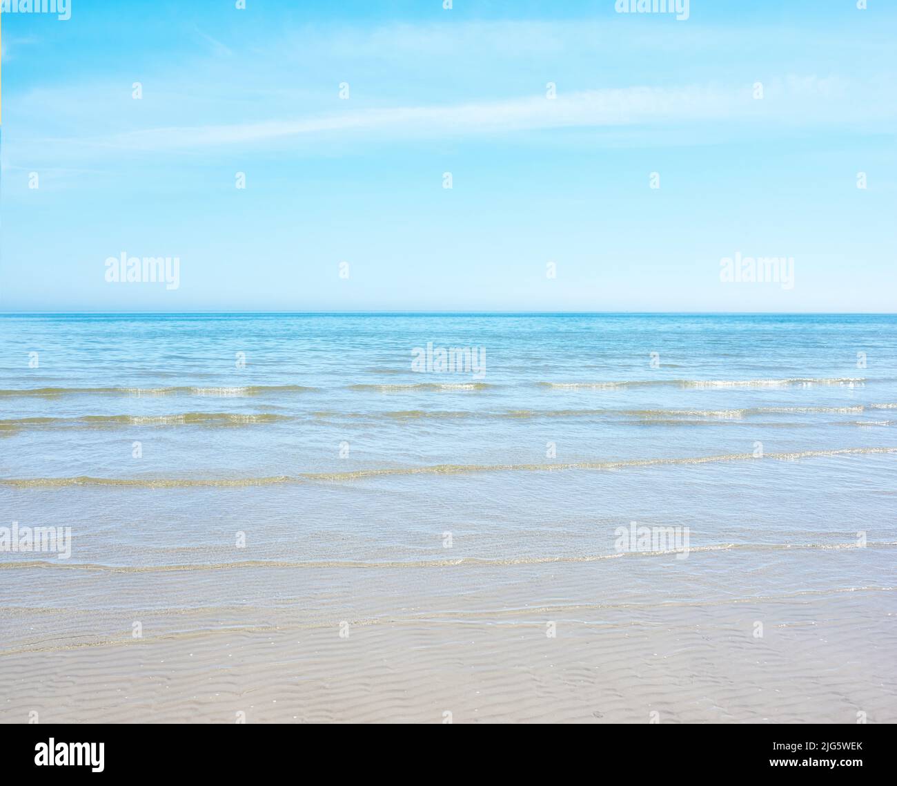 Copy space at the beach with a blue sky background above the horizon ...