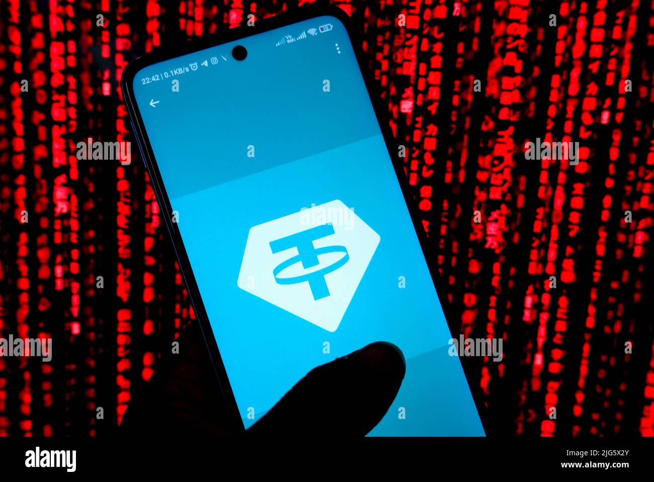 In this photo illustration, a Tether logo seen displayed on a ...