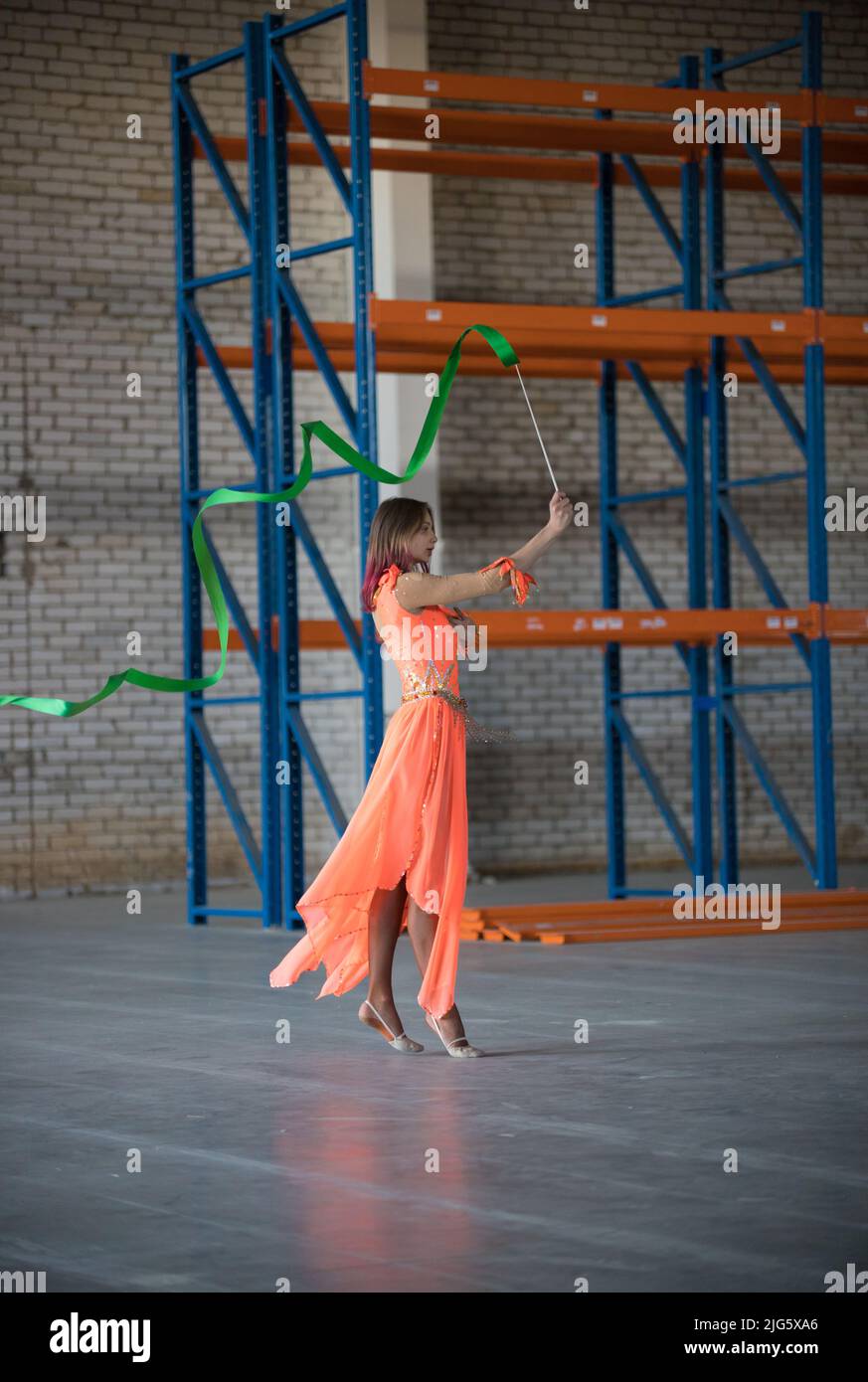 Young woman staying with gymnastic ribbon in hands indoor Stock Photo ...