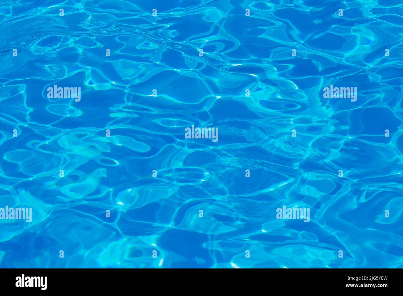 Swimming pool water surface with sparkling light reflections. Aqua ...