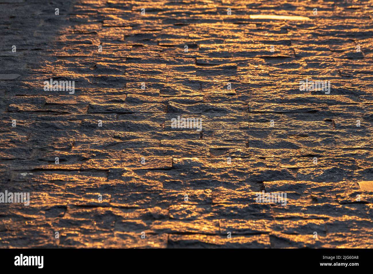 Stone pavement in the rays of the setting sun. Backround of Block ...