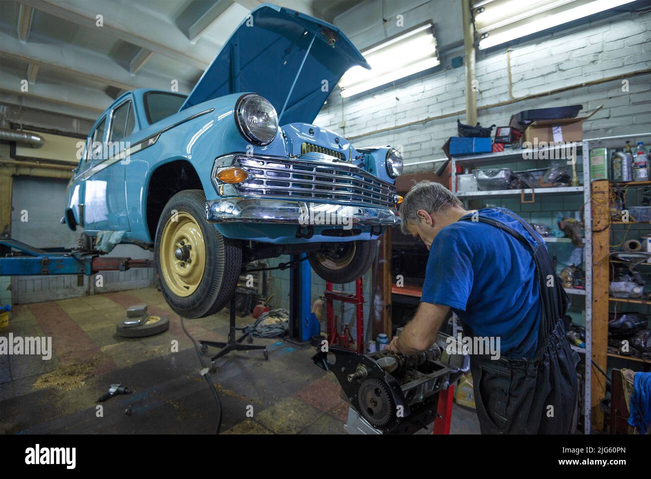 SAINT PETERSBURG, RUSSIA - AUGUST 03, 2020: Auto mechanic repairs the ...