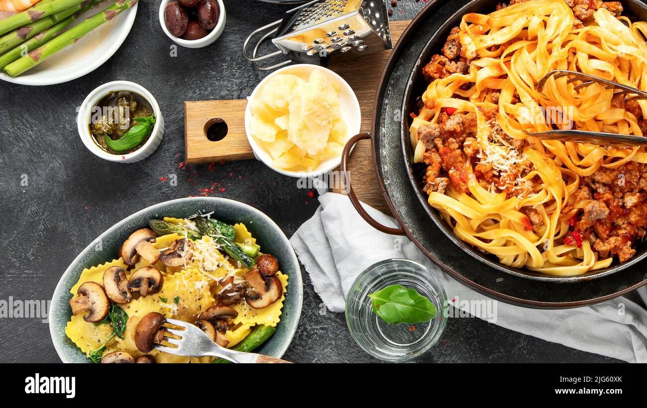 Table of italian meals on plates pasta Bolognese, ravioli, penne with ...