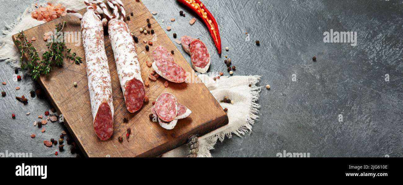 Traditional Spanish fuet on gray background. Dry cured pork sausages ...