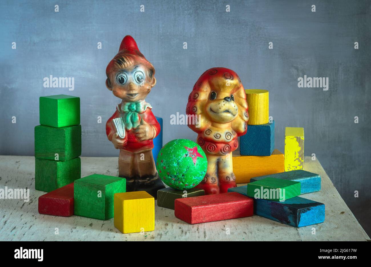 Still life with old rubber dolls and wooden cubes. Toys. Vintage Stock ...