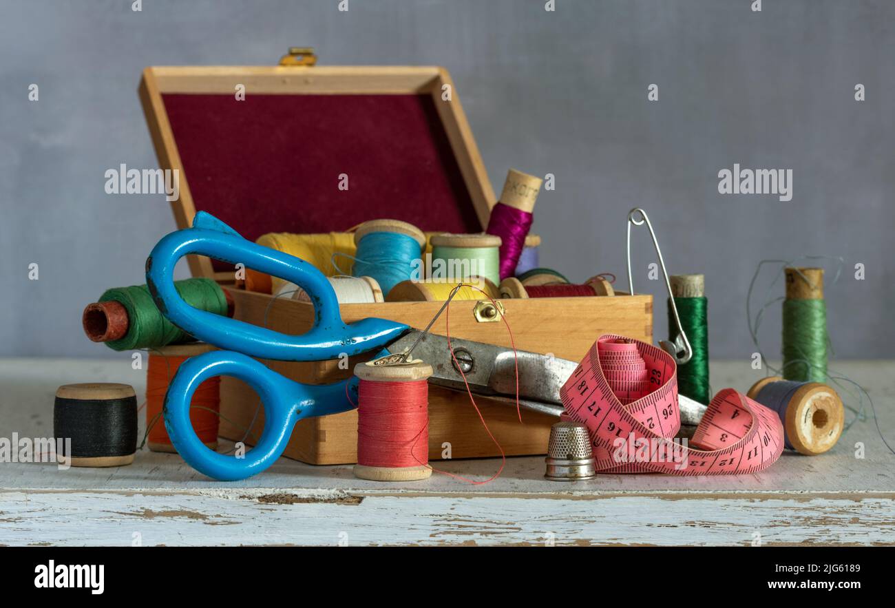 Still life with sewing accessories and a box. Vintage Stock Photo - Alamy