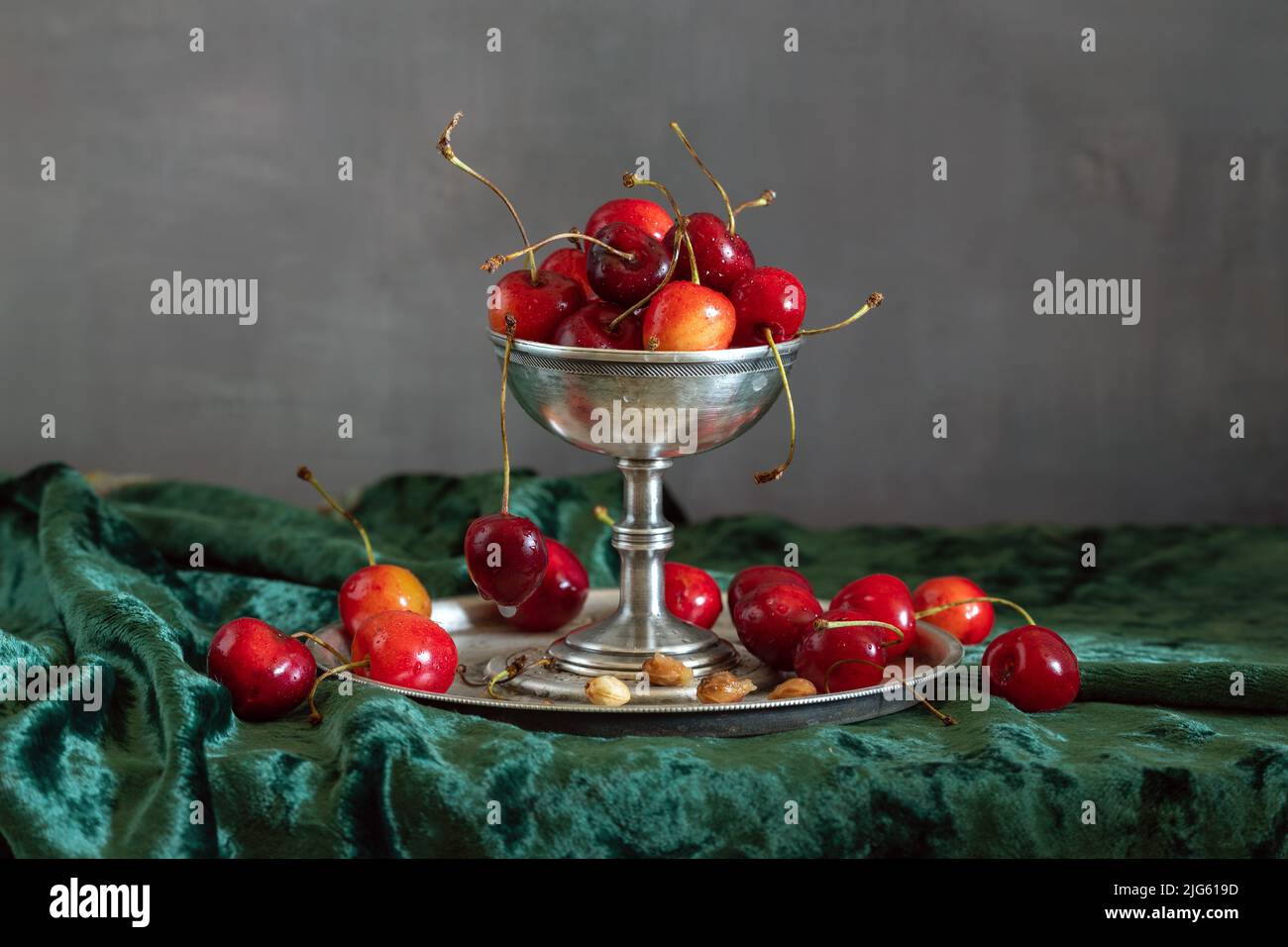 Still life with ripe and tasty cherries in a silver bowl Stock Photo ...