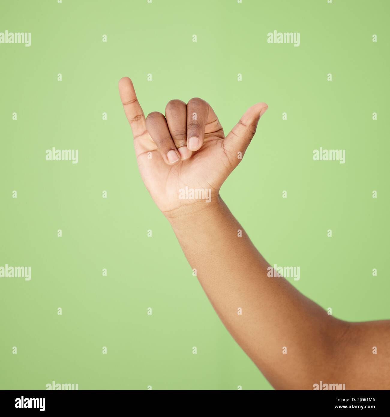 Hey there you. Cropped shot of a man showing a hand sign against a ...