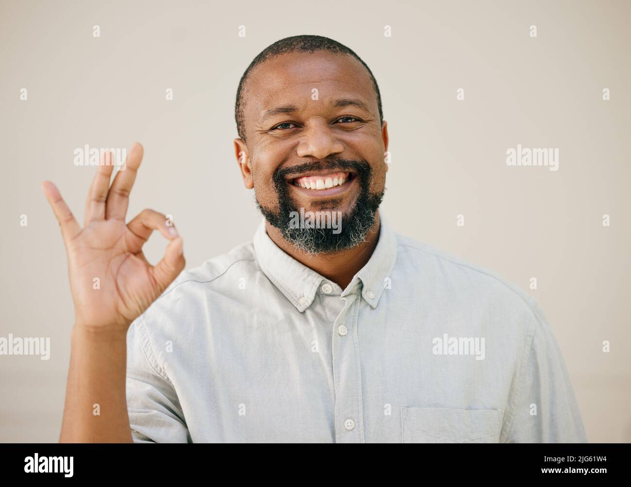 Everything is going to be ok. Shot of a man showing the ok sign while ...