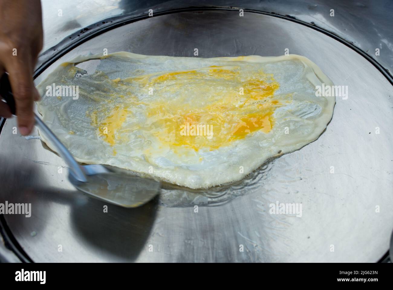 Hot crispy Roti with eggs, sweet dessert fried on hot pan Stock Photo ...