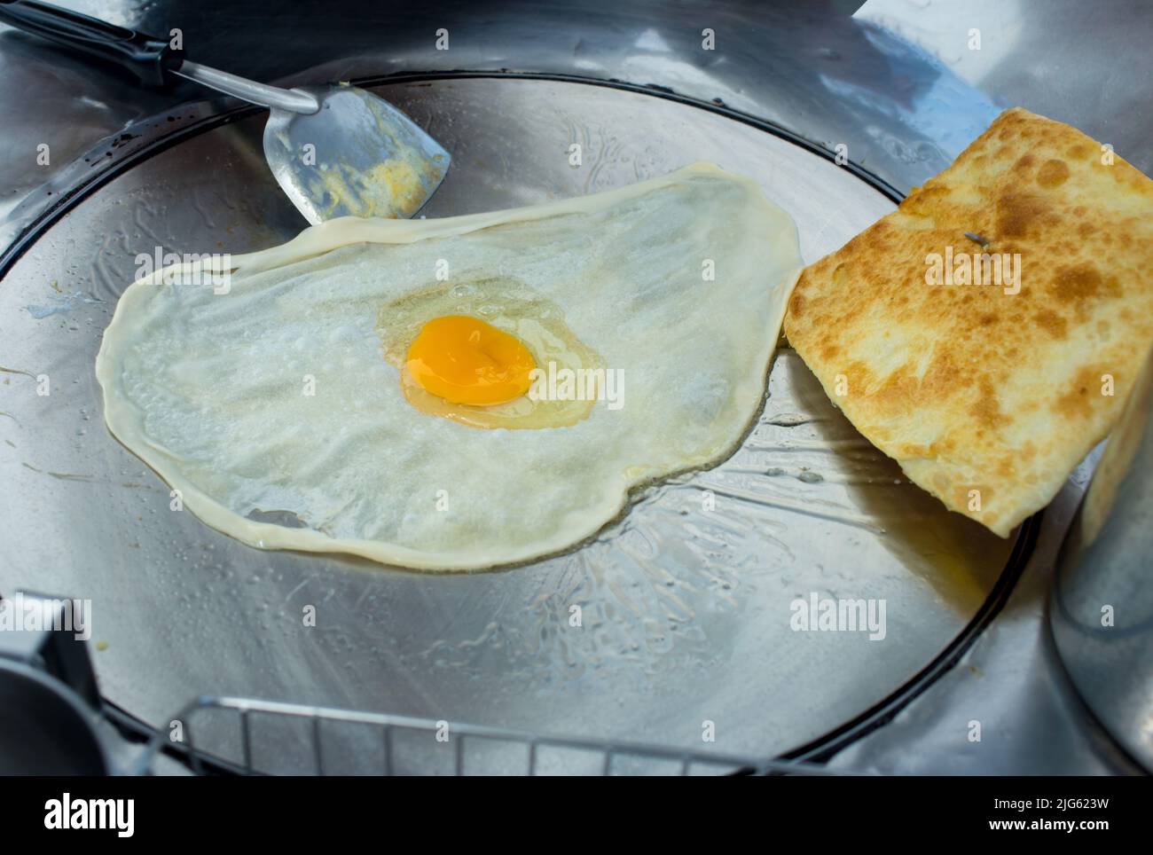 Hot crispy Roti with eggs, sweet dessert fried on hot pan Stock Photo ...