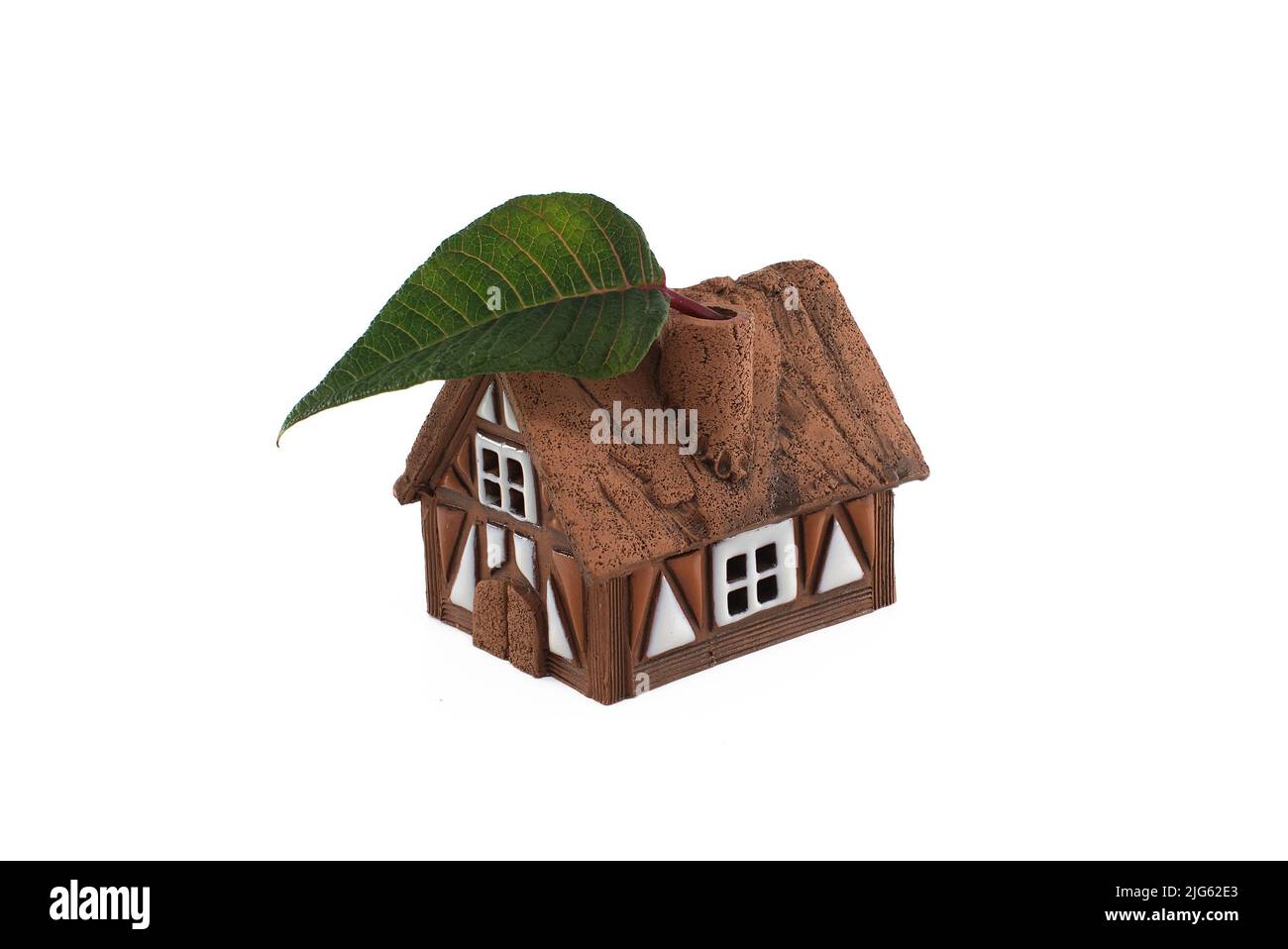 Clay house and green leaf. The concept of ecology and environmental ...