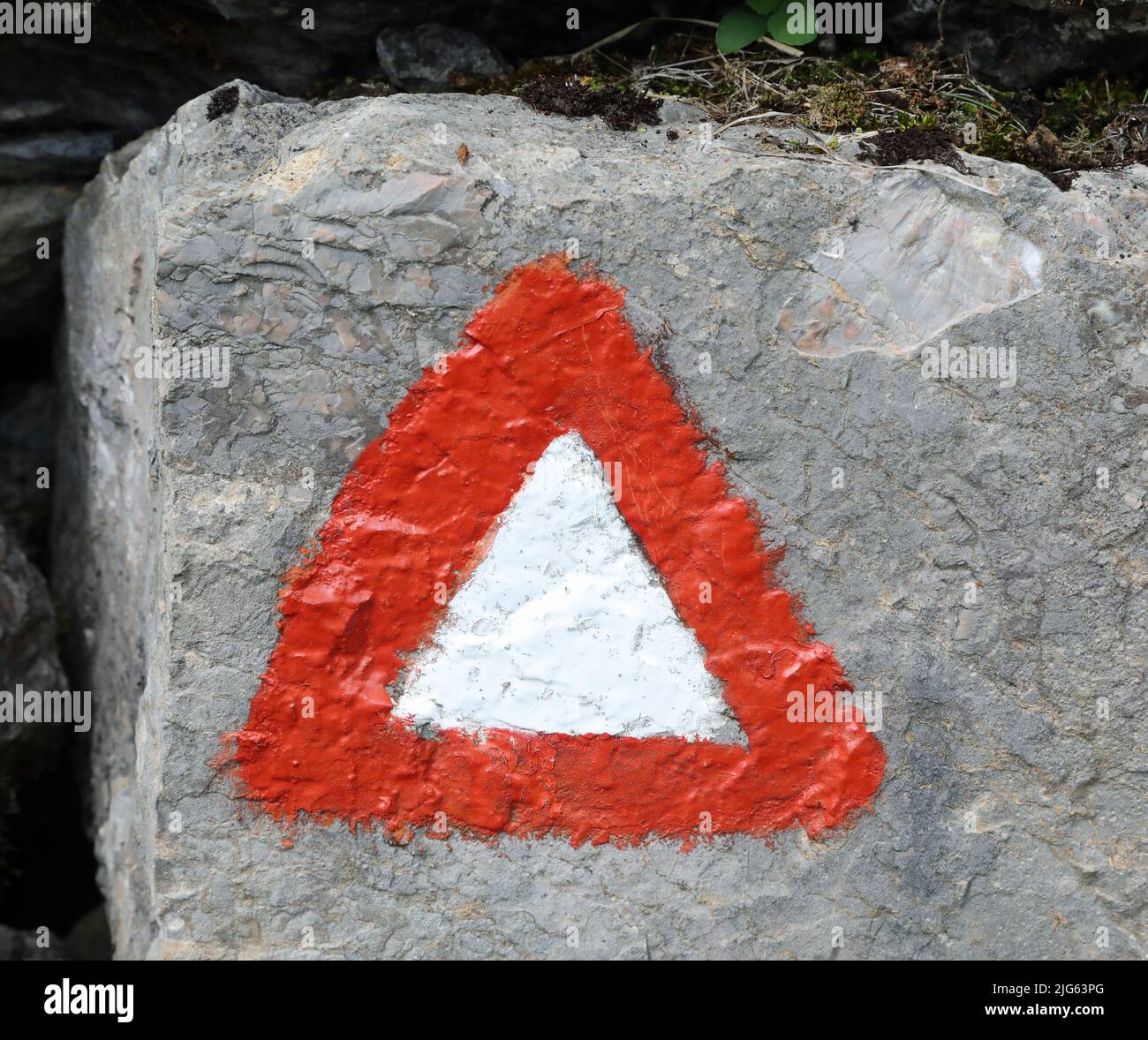 two large white and red triangles one inside the other to indicate the ...