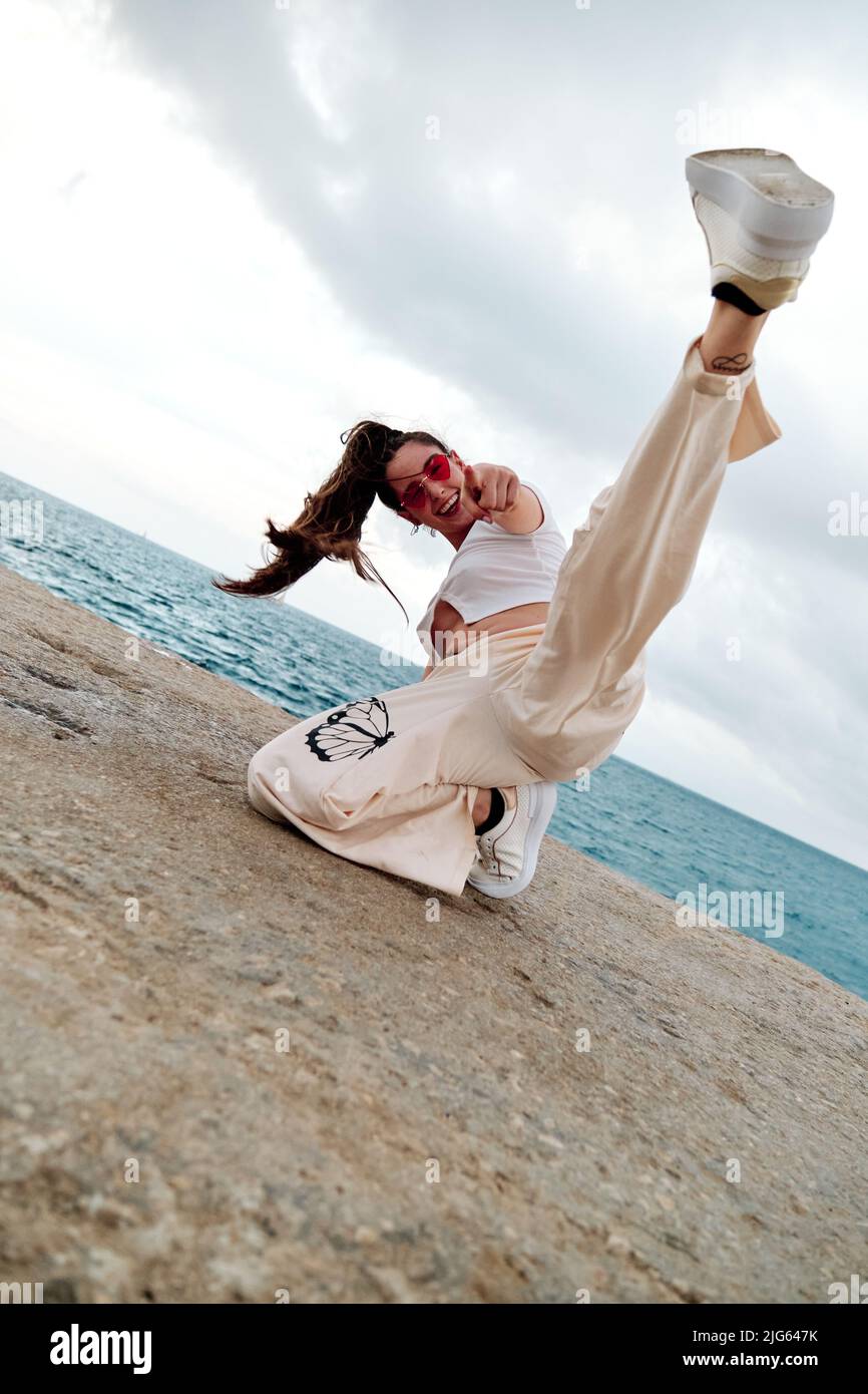 Female hip-hop dancer smiling while making a freestyle dance pose ...