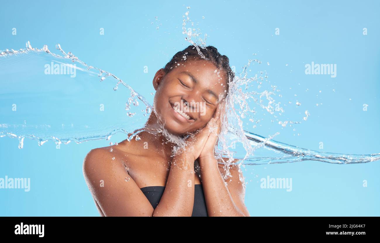 Night time protection. Shot of a beautiful young woman being splashed ...