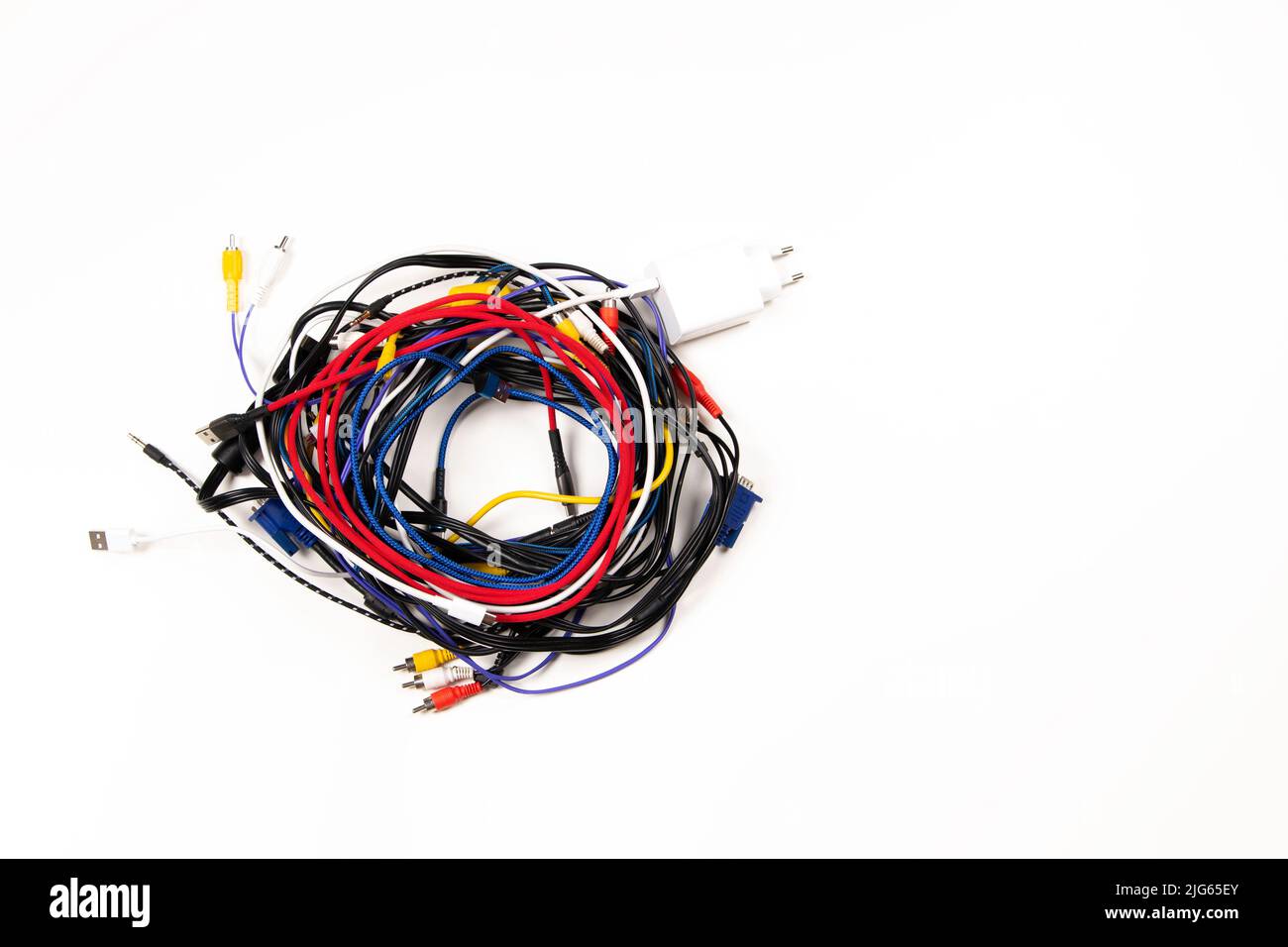 Many colorful electrical cord wires cord cables twist coiled into pile ...