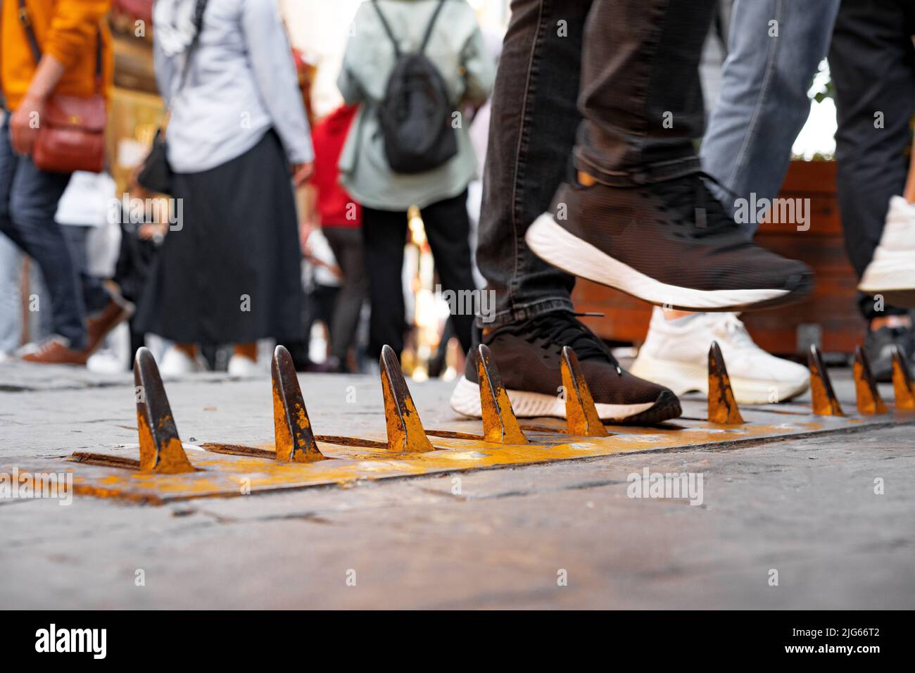Close-up of yellow spikes for a tire puncture for stopping the car in a ...