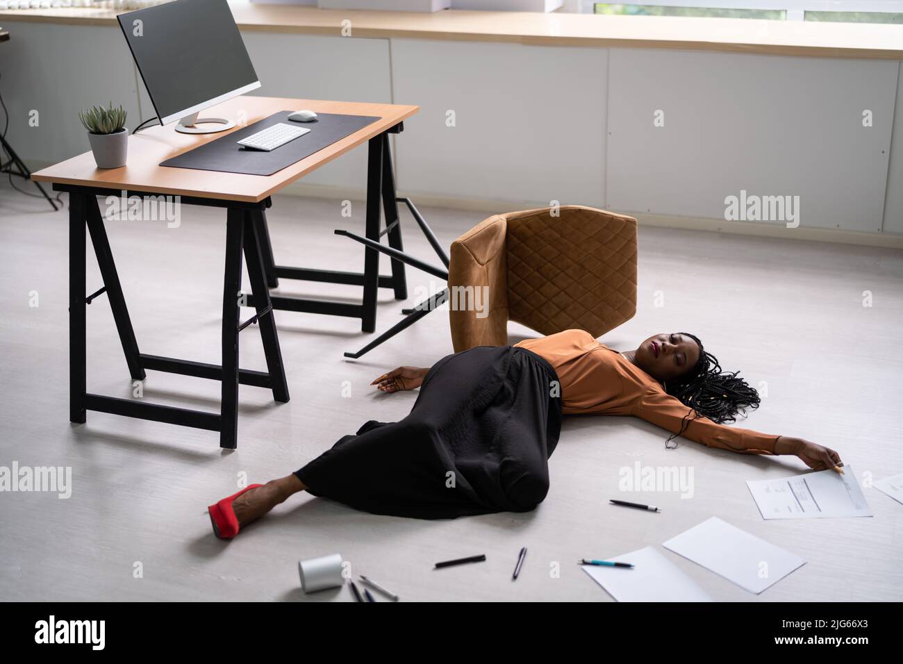 Full length of young businesswoman fallen from office chair Stock Photo ...
