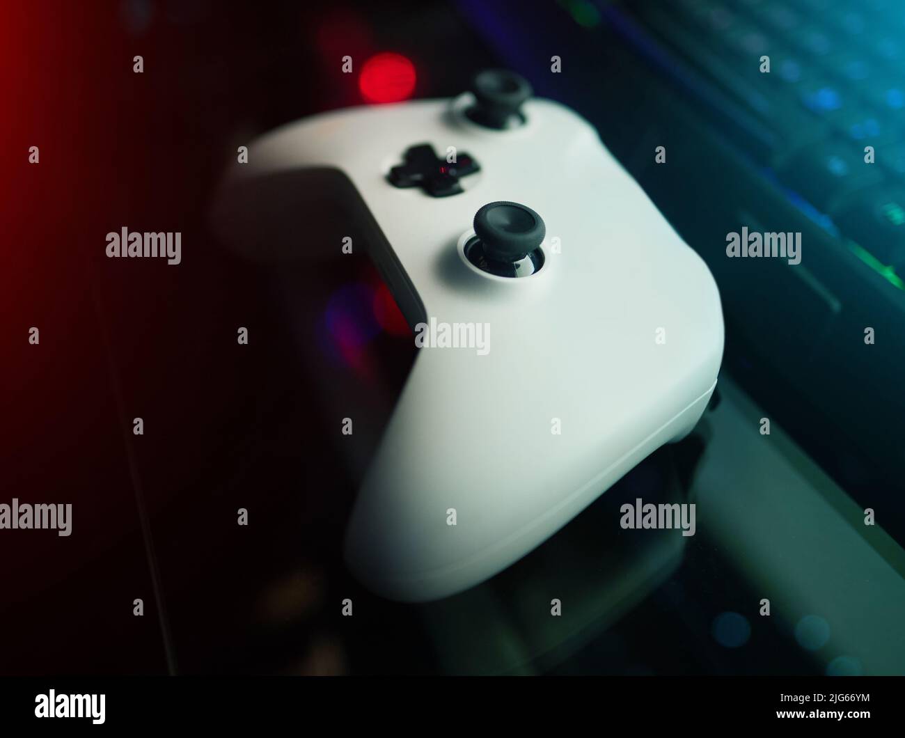 The mancave awaits. High angle shot of a console remote on a desk in a ...