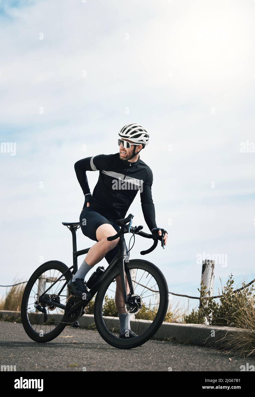 Man looking back cycling hi-res stock photography and images - Alamy