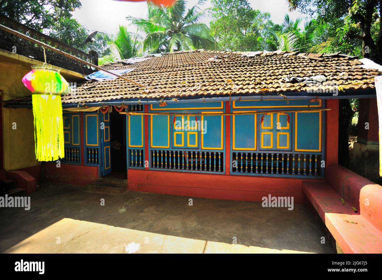 Traditional roof tiled and colored house from Konkan region at village ...