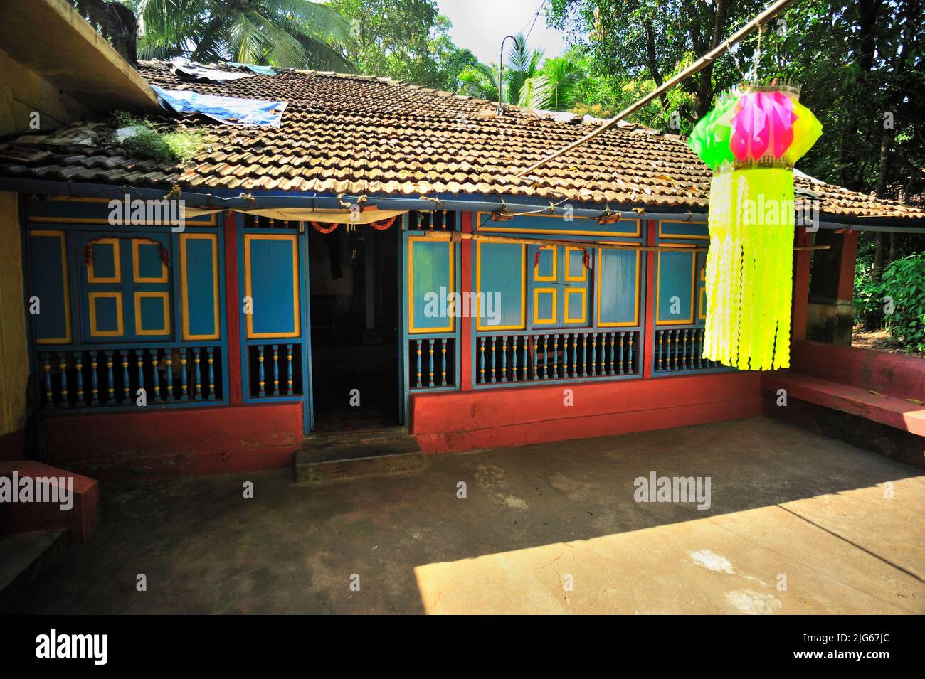 Traditional roof tiled and colored house from Konkan region at village ...