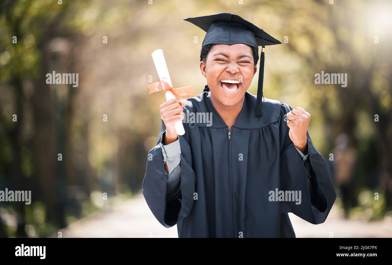 Victory is mine. Portrait of a young woman cheering on graduation day ...
