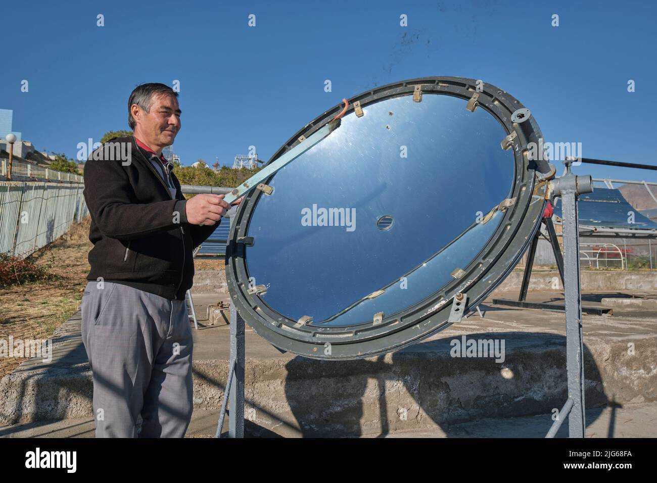 A scientist demonstrates the power of the concentrated sun by lighting ...